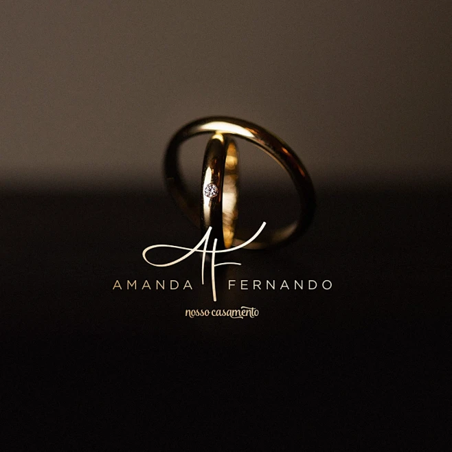 This may contain: two gold wedding rings with the word amanda fernando ...