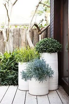 Keep it simple and make a statement outdoors. Layer pots planted with ...