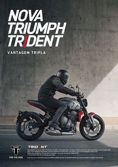 a man riding on the back of a red motorcycle next to a wall with words ...