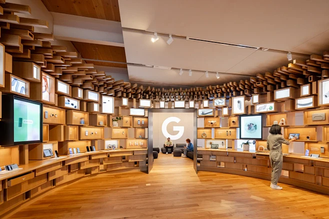 A photo of the interior of the Google Store with a woman looking at the ...