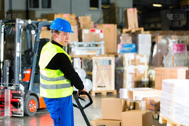Storeman with mover at warehouse of forwarding