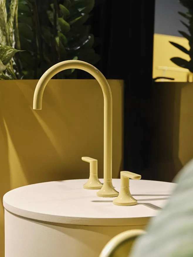 This may contain: a yellow faucet sitting on top of a white table next ...