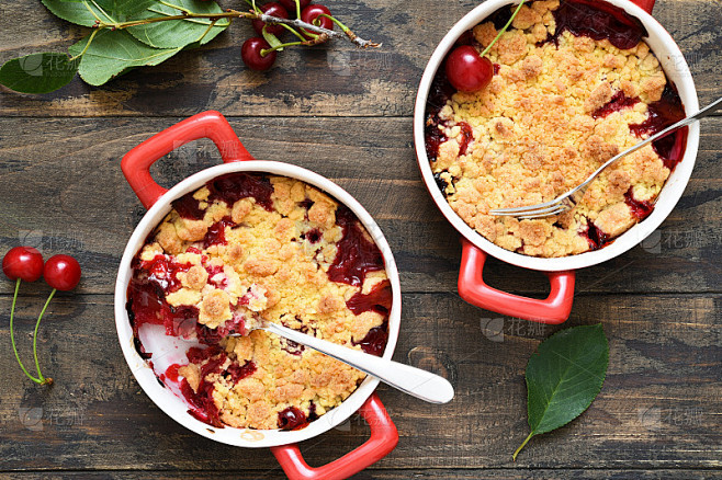 Homemade crumble with cherries and nuts on a woode
