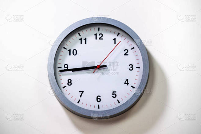 Grey Wall Clock show the time. Modern wall clock w