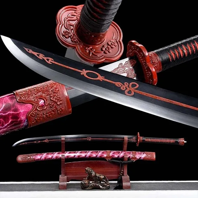 This may contain: two red and black swords are on display in front of a ...