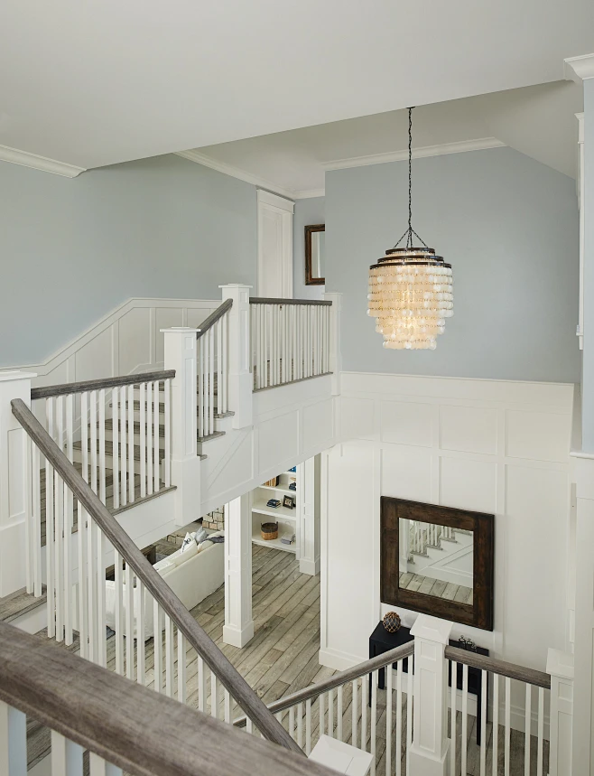 Staircase - coastal wooden u-shaped wood railing and wall paneling ...