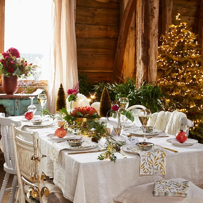 Christmas dining table, laid out table settings, white table cloth and ...