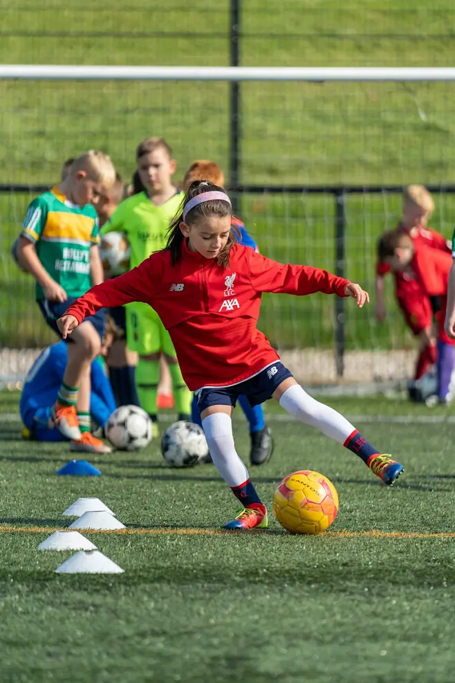 Photo by Danny Nee on Unsplash : Young girl in Liverpool FC kit taking ...