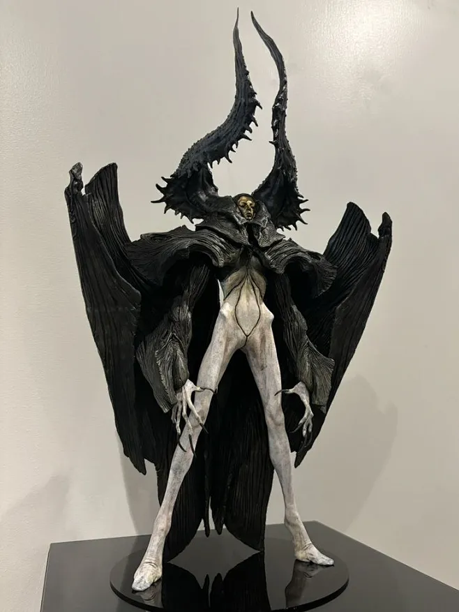 This may contain: a statue of a demon with wings and claws on it's head ...