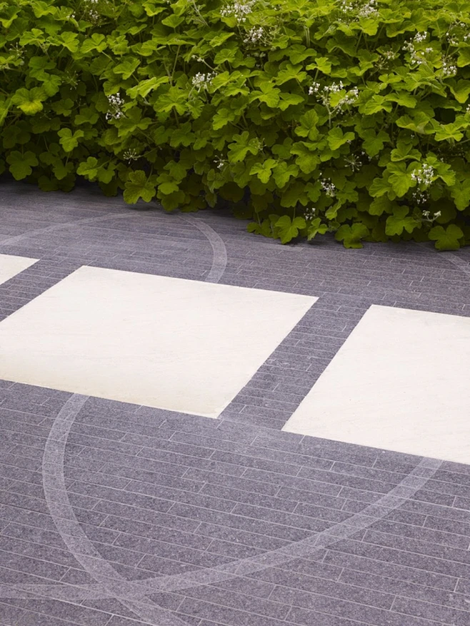 The garden employs large swaths of contrasting materials to create a ...