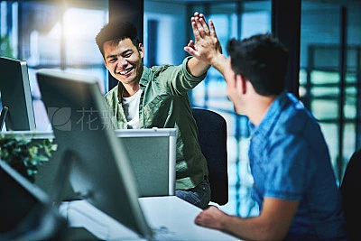 Great job, man!Cropped shot of two young male designers high fiving ...