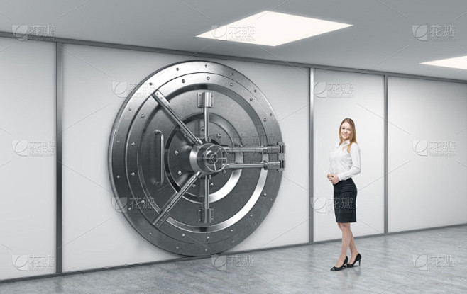female bank worker standing in front of a big lock