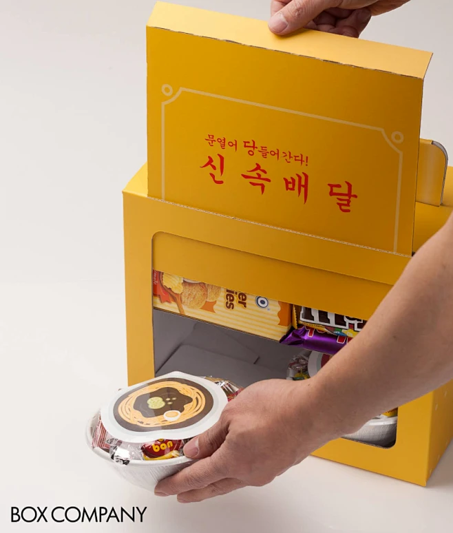 This may contain: a person holding a box with food in it and another ...