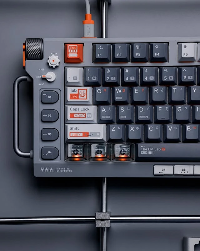 This may contain: a computer keyboard sitting on top of a metal table ...