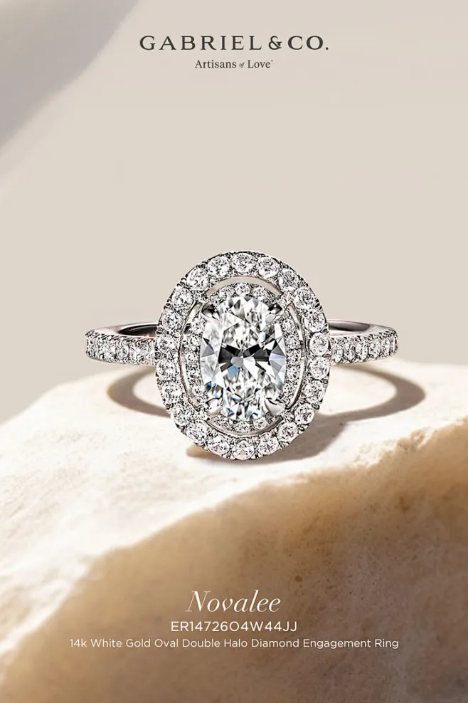 This breathtaking double halo engagement ring offers a glamorous twist ...