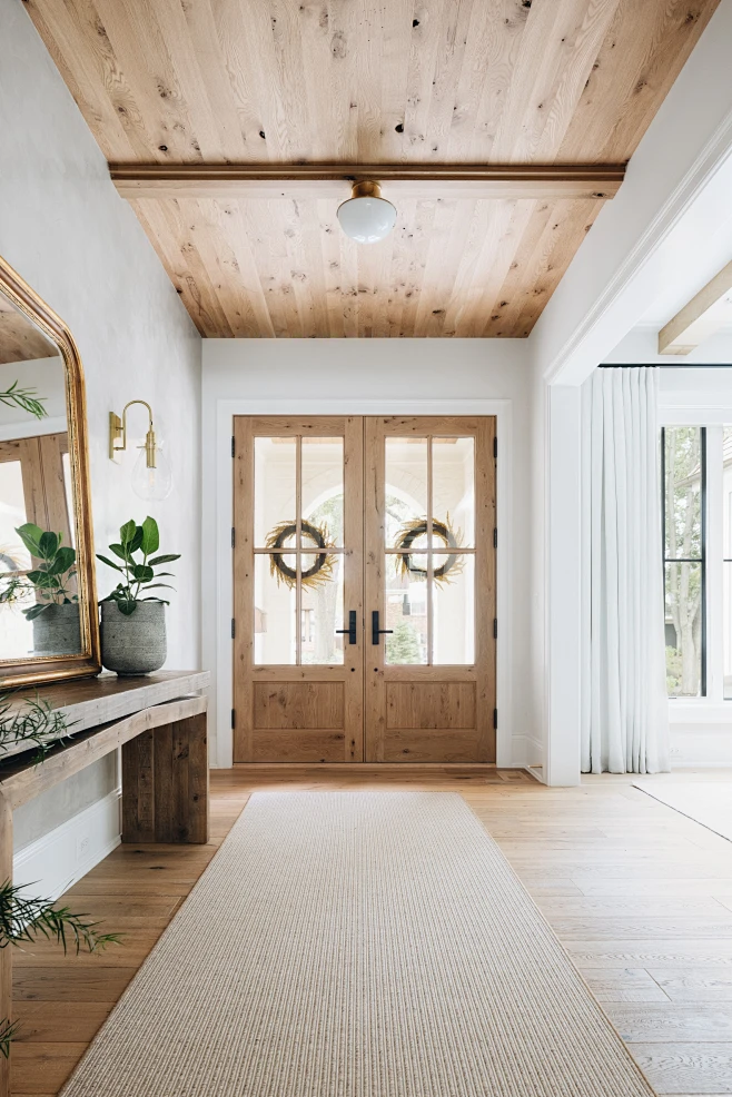Entryway - large transitional light wood floor, brown floor and wood ...