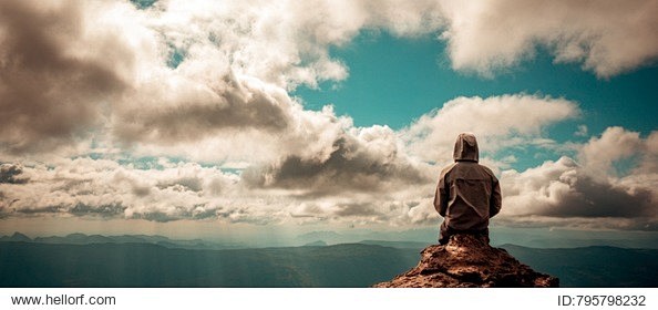 alone man sitting on the peak of mountian cloudy sky lonely scene ...