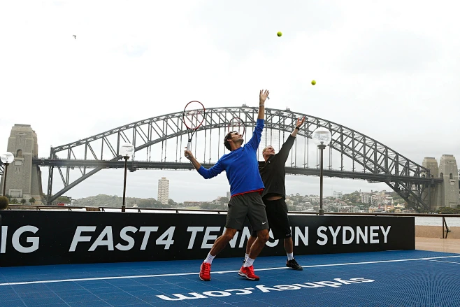 Roger Federer and Lleyton Hewitt play tennis during the launch of Fast4 ...