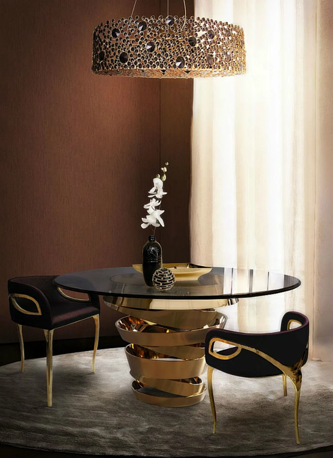 INTUITION by KOKET is a round dining table with two metal tones and a ...