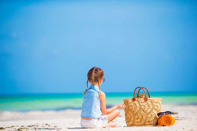 Adorable little girl with beach bag and towel during summer vacation by ...