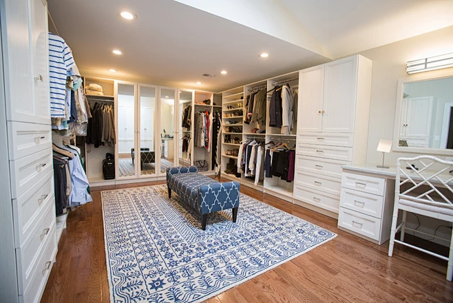 Large transitional gender-neutral medium tone wood floor walk-in closet ...
