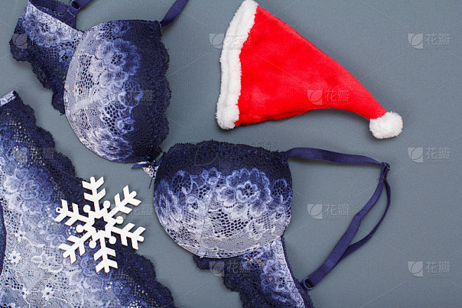 Blue lace bra and panties with Santa's hat on gray