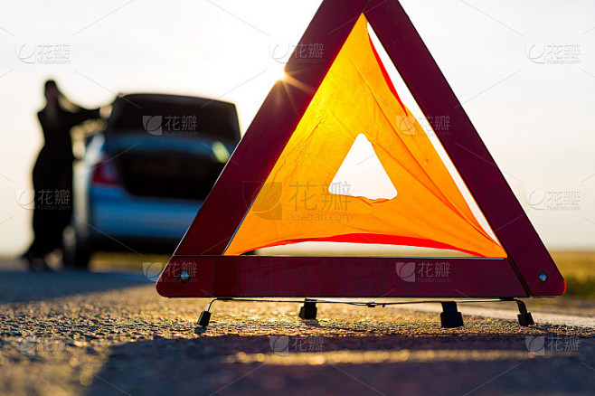 Emergency triangle sign set on road near broken ca