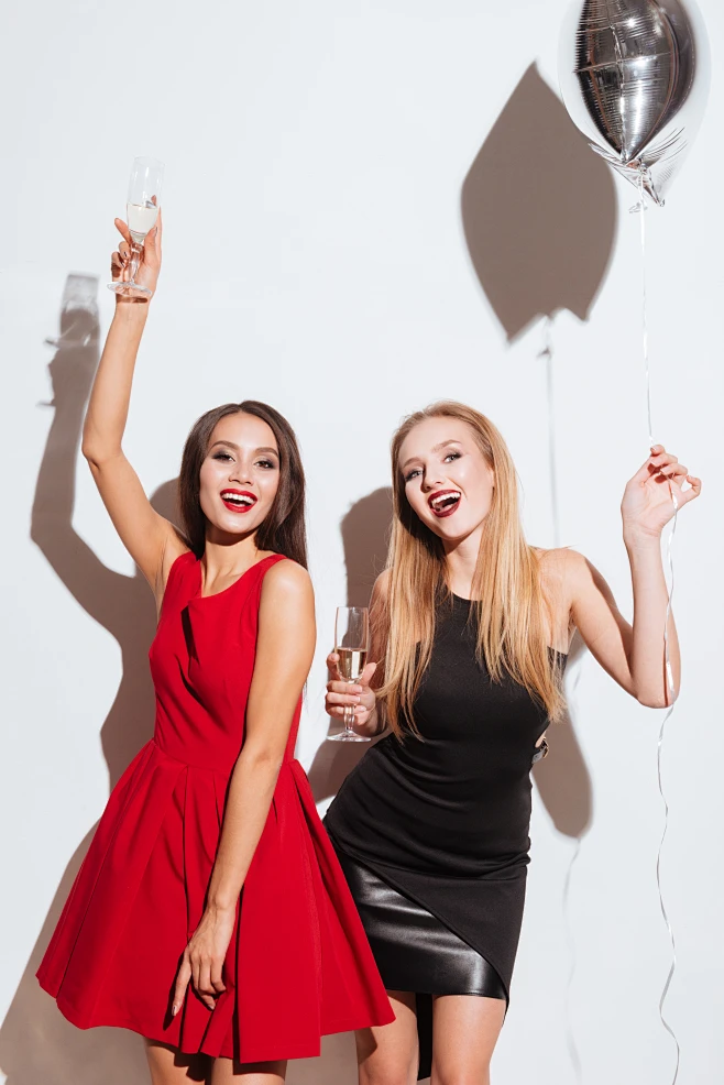 two-cheerful-beautiful-young-women-drinking-champagne-dancing-white ...