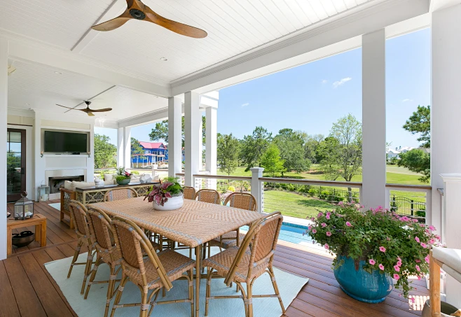 Beach style cable railing porch photo in Charleston with a fireplace ...