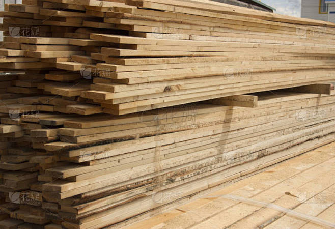 Lumber warehouse. Long wood planks stacked outdoor