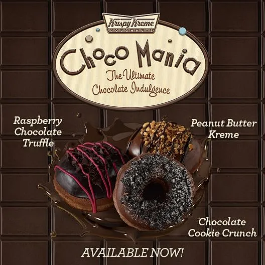 chocolate covered donuts are on display in front of a sign that says ...
