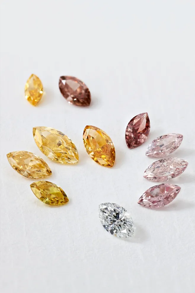This may contain: five different colored diamonds on a white surface ...