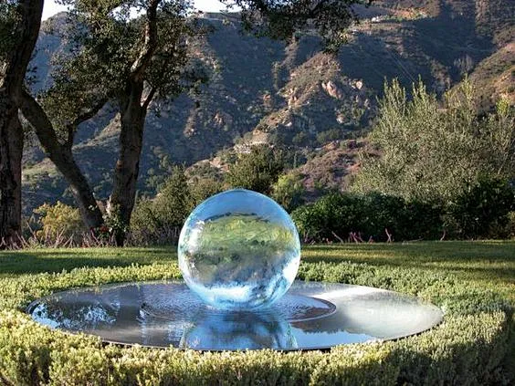 A hidden pump sends gentle streams of water down the sides of the 2 ...