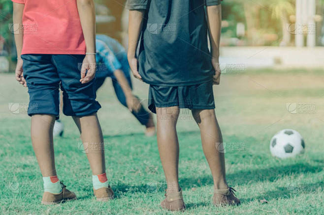 亚洲男孩练习踢皮球进球