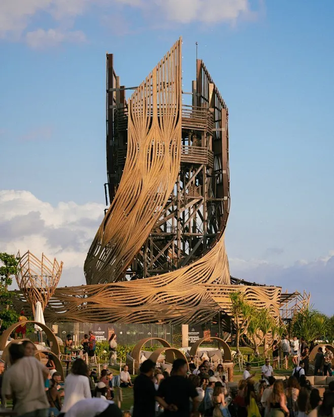 This may contain: a large wooden structure sitting on top of a lush ...