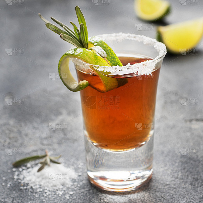 Glass with alcohol, salt and lime on a dark concre