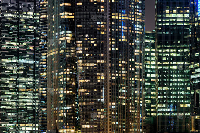 晚上，摩天大楼闪闪发光的窗户。晚上的城市