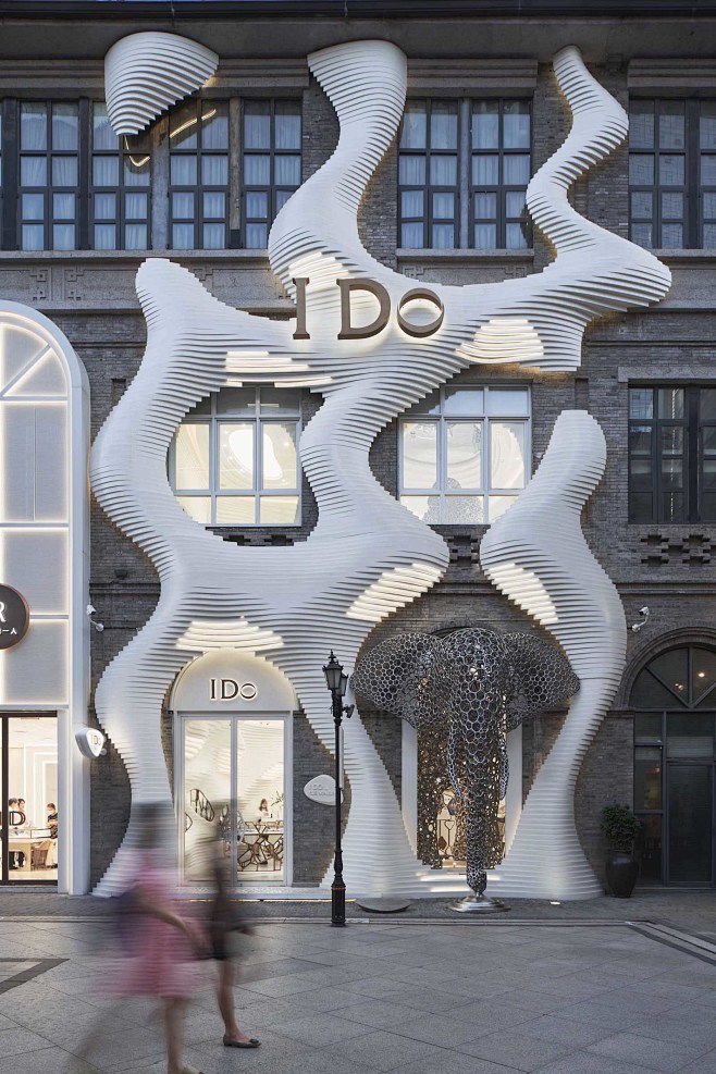 A modern retail store with an eye-catching facade, large sculptures ...