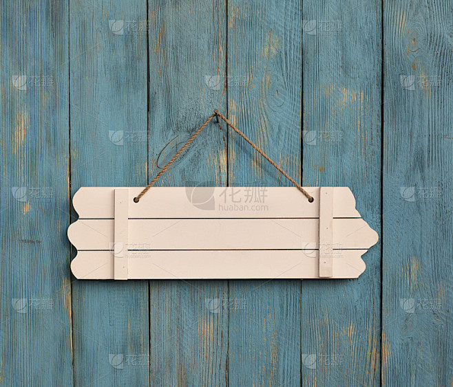 white wooden sign on a blue wooden wall