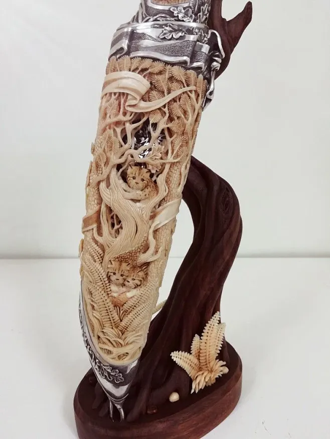 This may contain: a sculpture of a toothbrush with intricate carvings ...