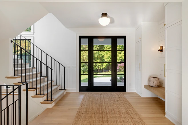 Example of a mid-sized medium tone wood floor and brown floor foyer ...