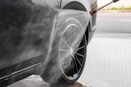 A man is washing a skoda rapid wheel at self service car wash. high ...