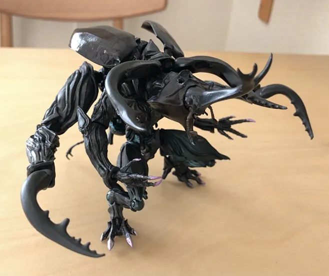 This may contain: a toy that looks like an alien with horns and claws ...