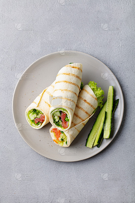 Wrap sandwich, roll with fish salmon and vegetable