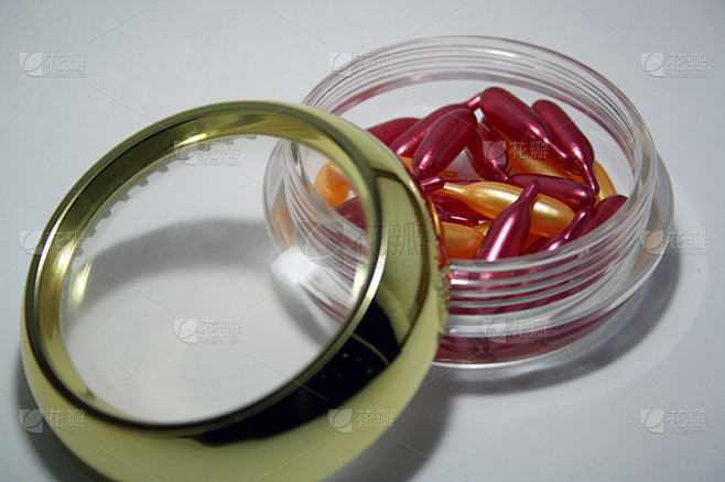 Gold capsules for face isolated on white backgroun