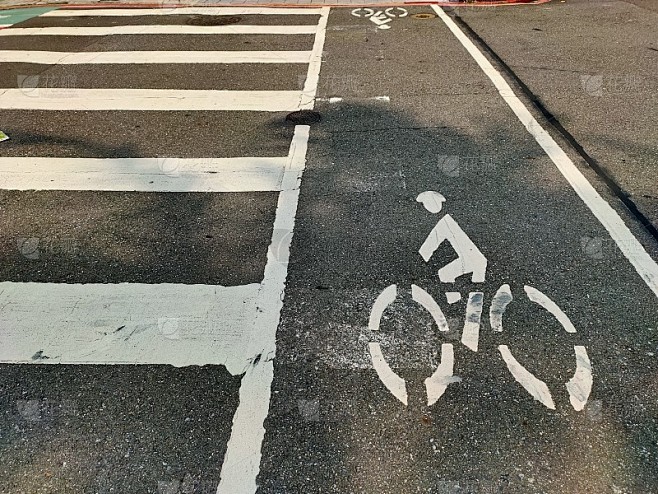 Zebra crossing and bicycle signs on the road.