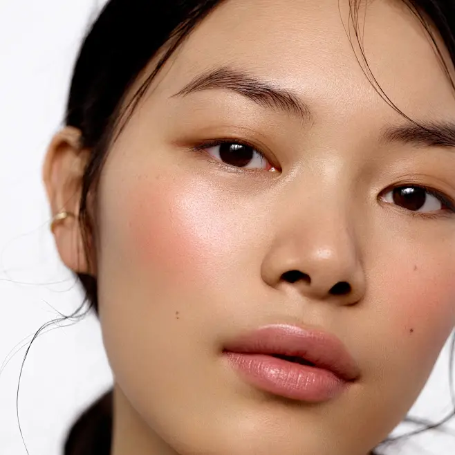 Image of a light skin tone model wearing the Cream Blush Refillable ...