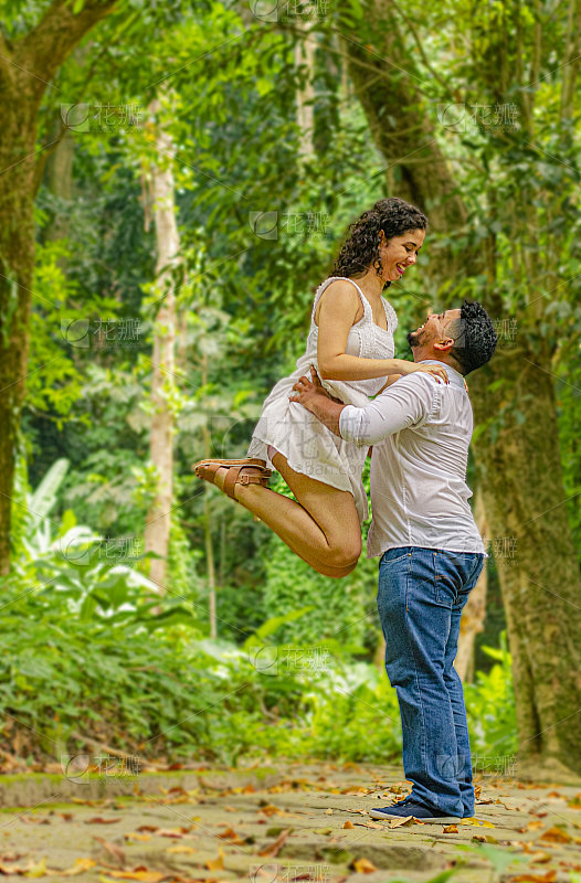 Man raising swirling woman running on top happy in