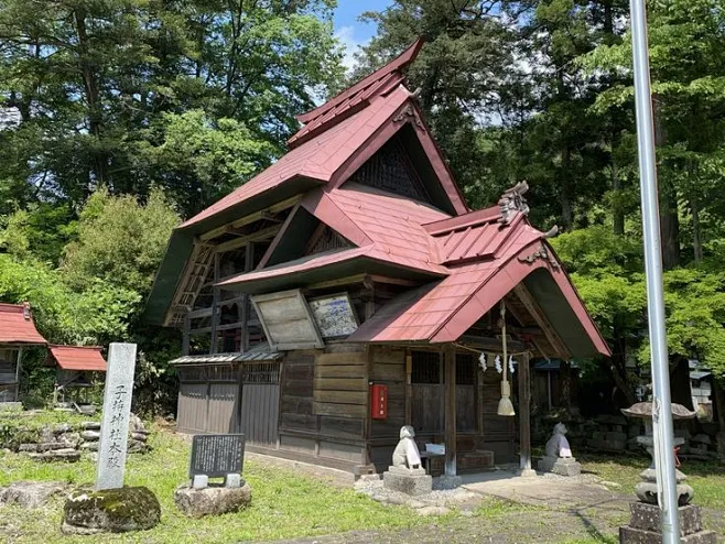 This may contain: a small wooden building with a red roof in the middle ...