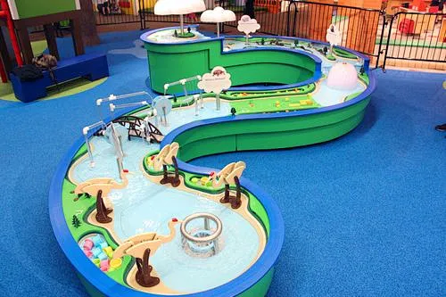 This may contain: children's play area with slides and water features ...